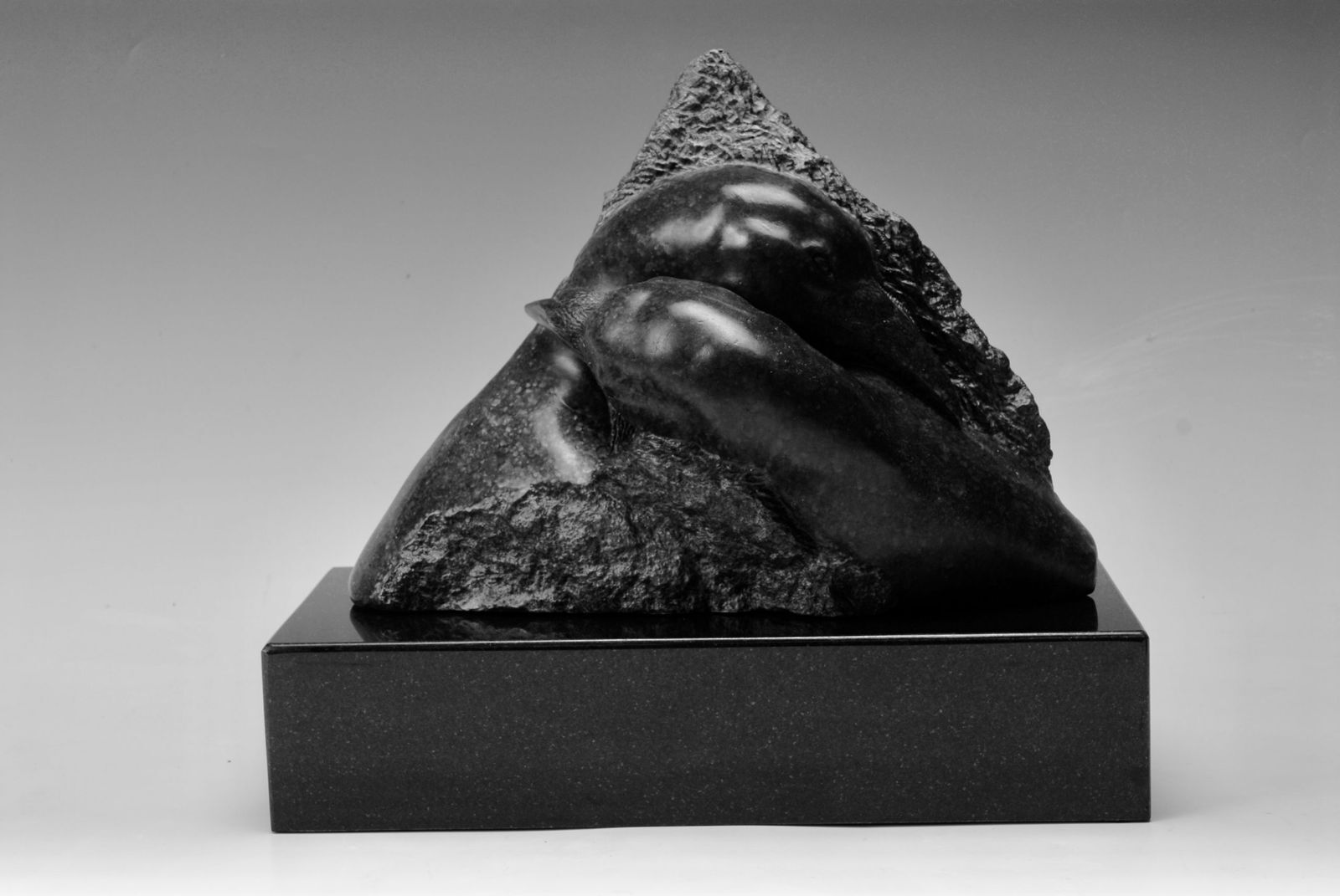 A Stone Sculpture of Ravens Embracing by Dale Weiler